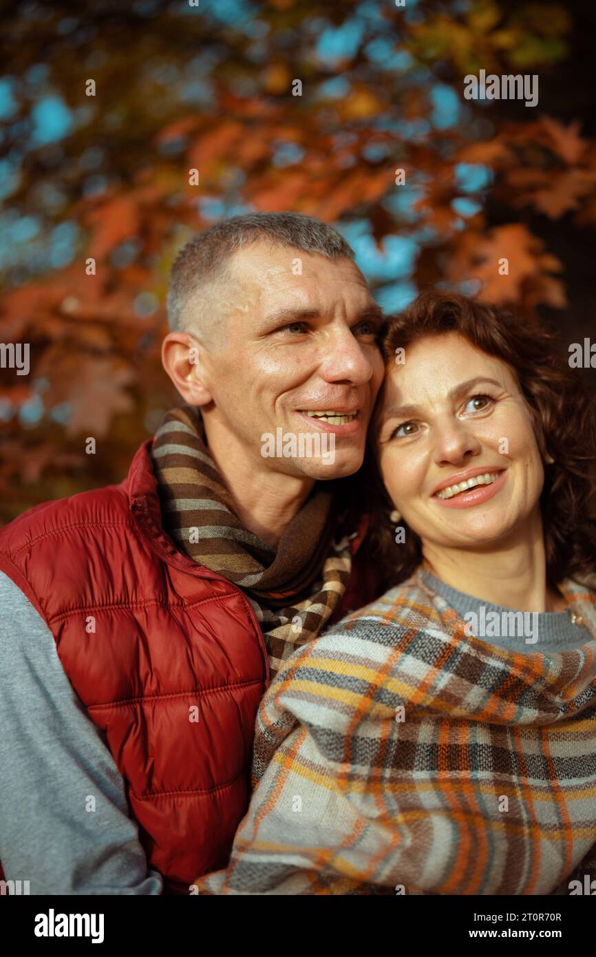 Hello autumn. happy romantic couple in the park embracing Stock Photo ...