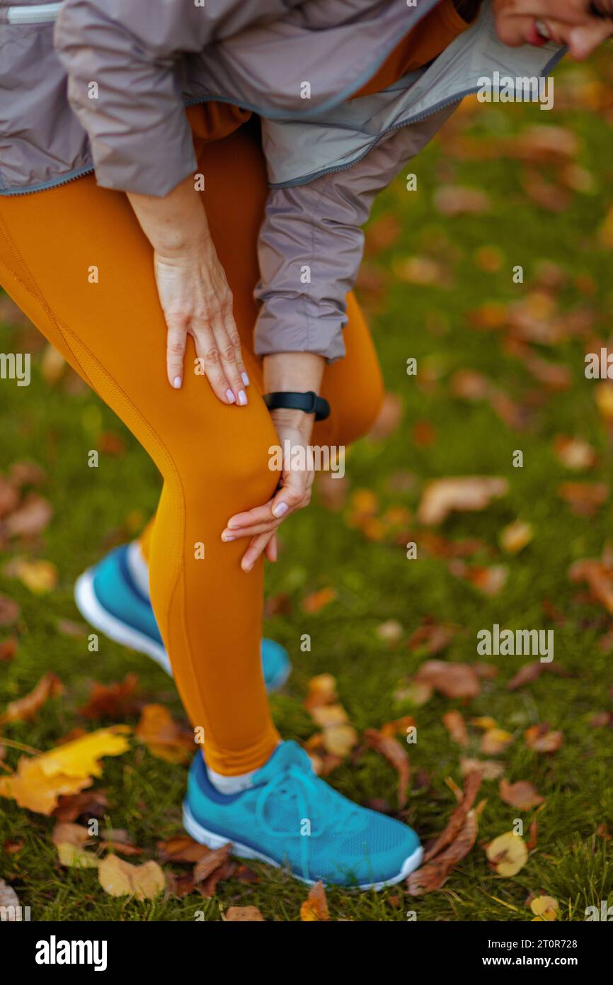 Hello autumn. Closeup on middle aged woman in fitness clothes in the ...