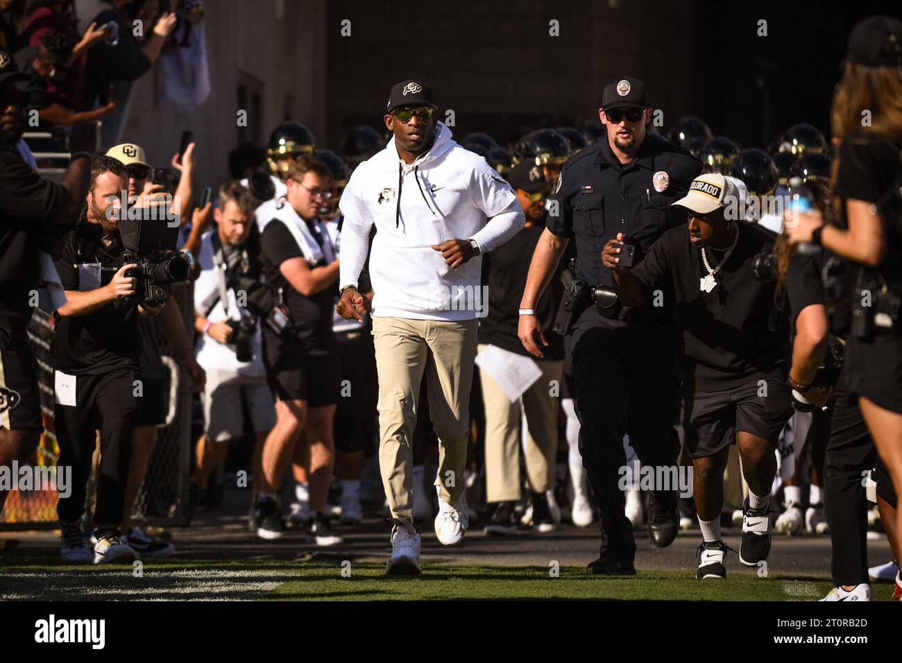Colorado Buffaloes head coach Deion Sanders runs onto the field before ...