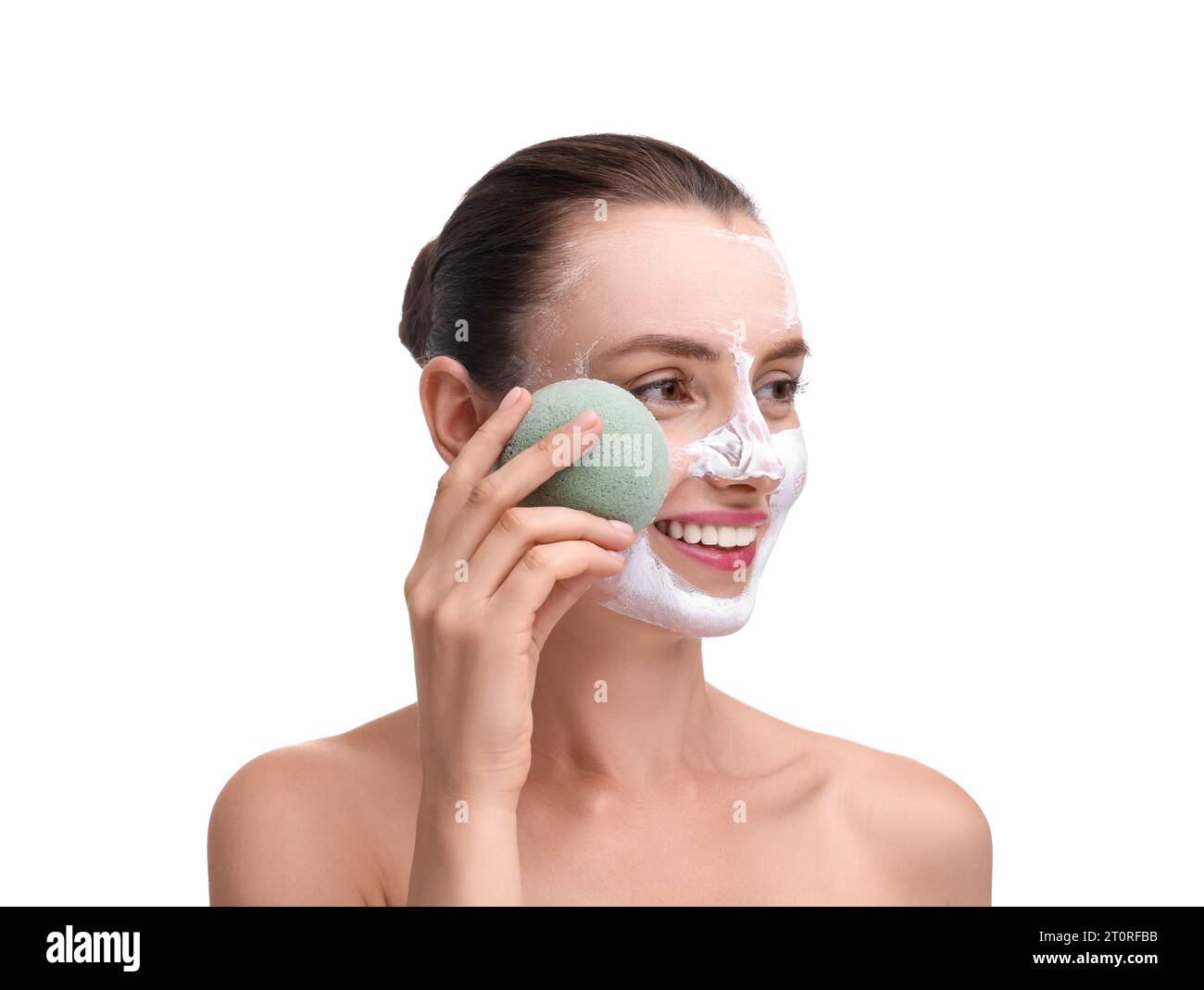 Happy young woman washing off face mask with sponge on white background ...