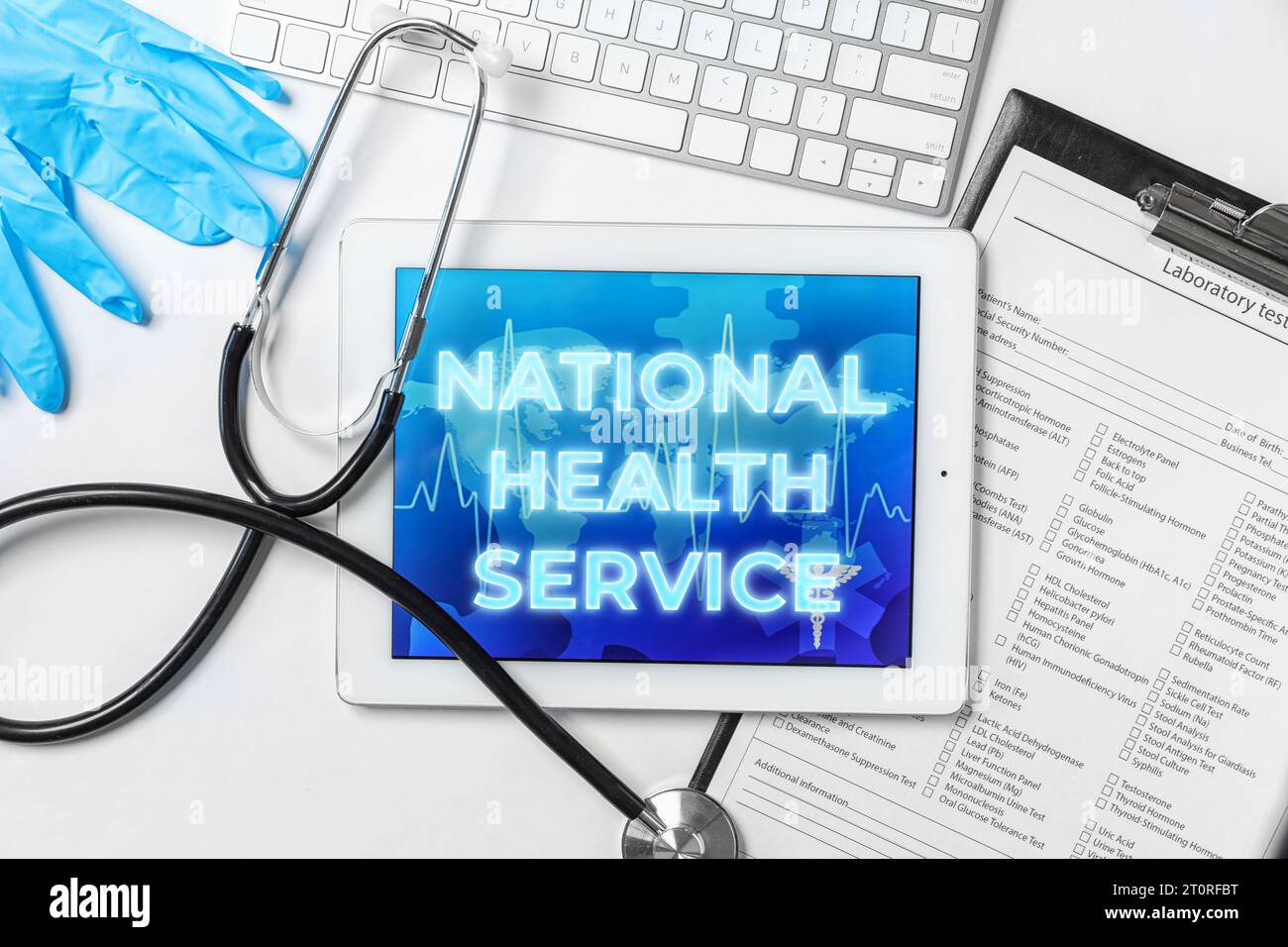 National health service (NHS). Tablet with text, stethoscope, text form ...