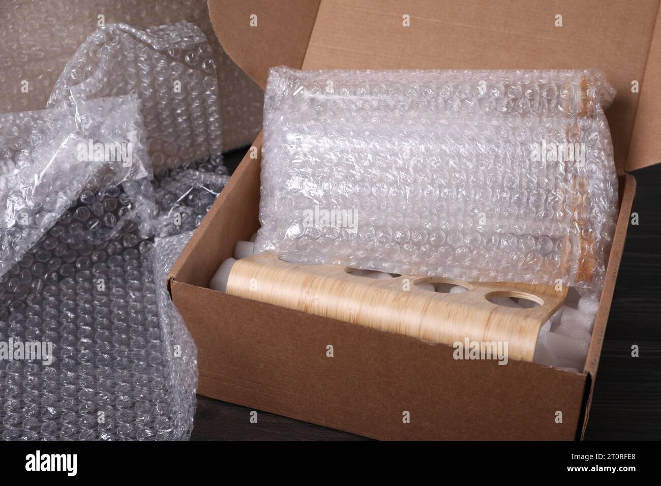 Test tubes in cardboard box and bubble wrap on dark wooden table Stock ...