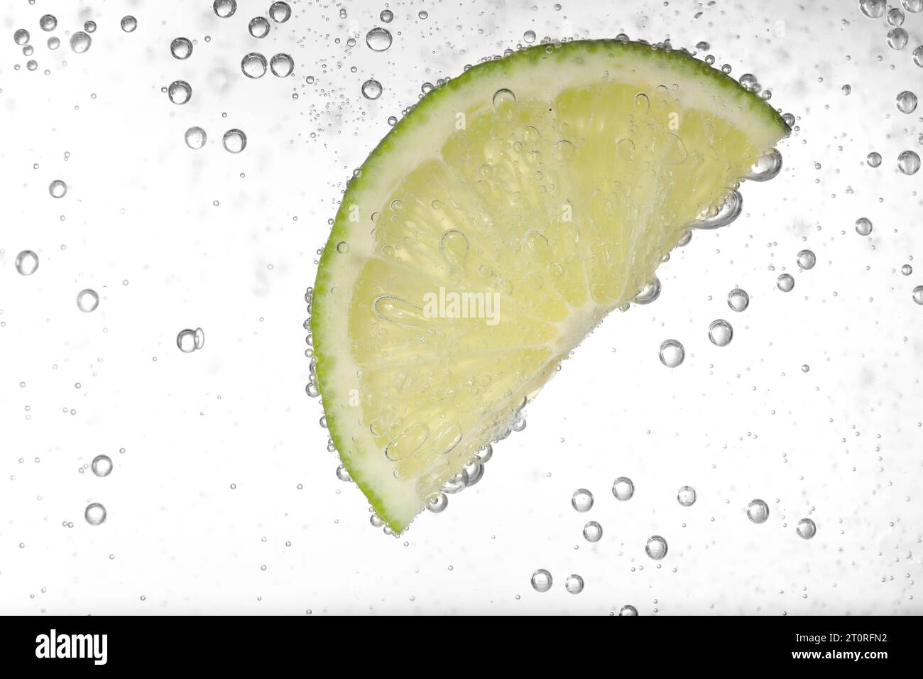 Juicy lime slice in soda water against white background, closeup Stock ...