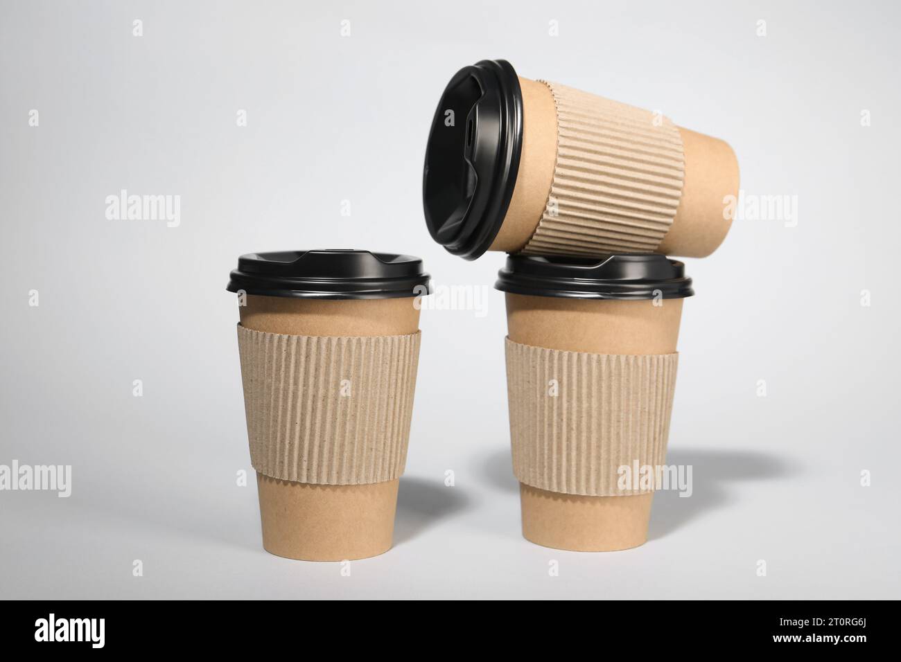 Paper cups with black lids on light gray background. Coffee to go Stock ...