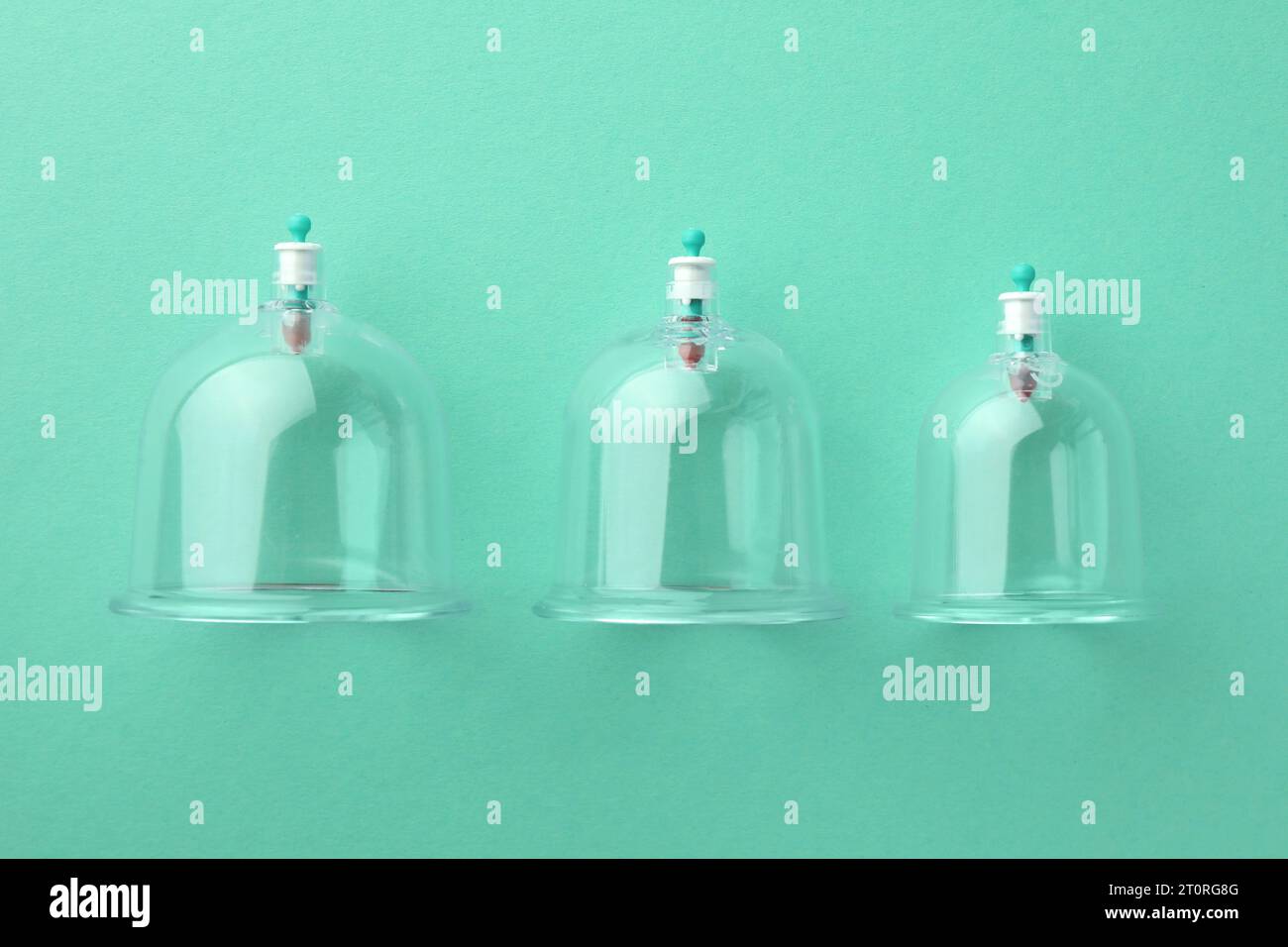 Plastic cups on turquoise background, flat lay. Cupping therapy Stock ...