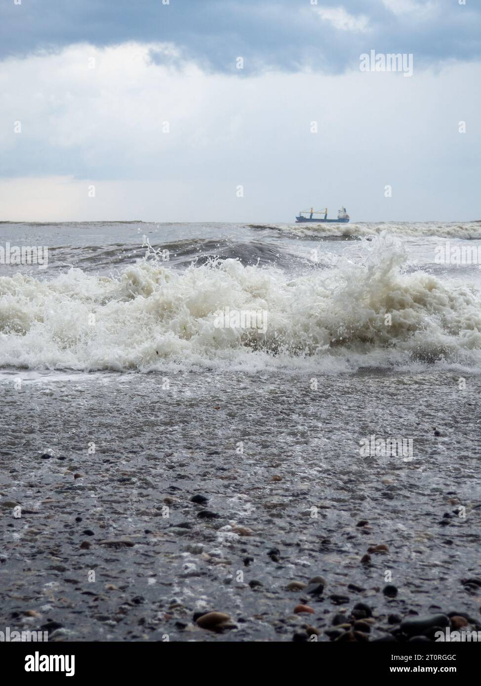 lonely ship in the middle of a rough sea. Barge in the distance. Big ...