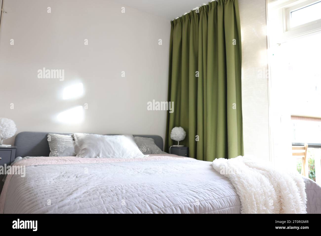 Stylish room interior with comfortable large bed Stock Photo - Alamy