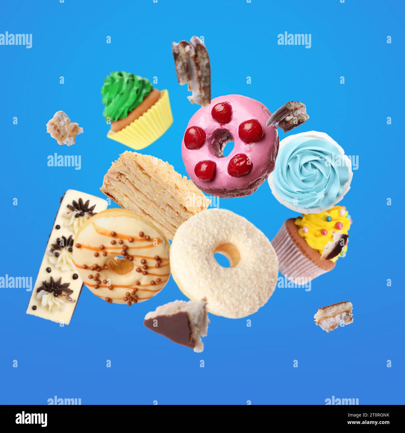 Many different tasty desserts flying on blue background Stock Photo - Alamy