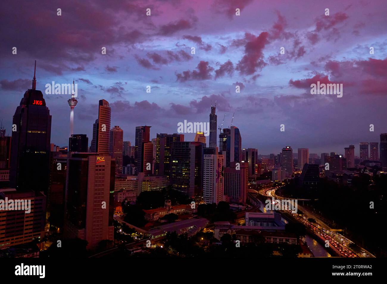 An incredible pink and purple sunset over a modern big city. Kuala ...