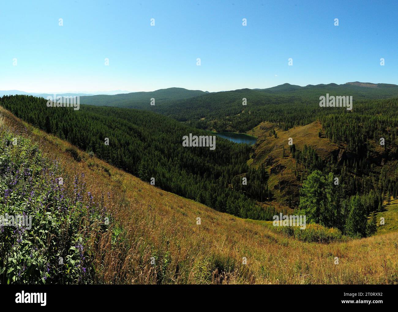 A view from the top of the hill through a crevice in the mountains to a ...