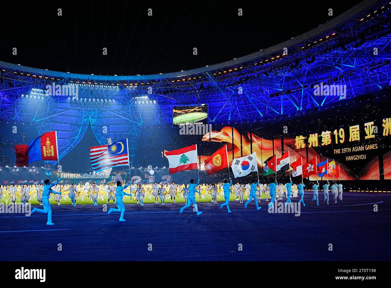 Flags of the participating countries are carried during the closing ...