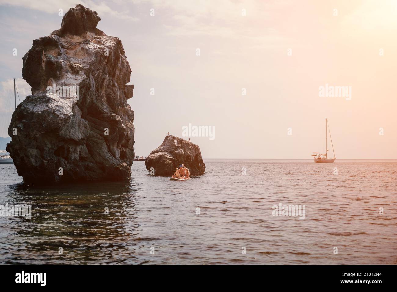 Family sea sup. Young happy father with his son and daughter Floating ...