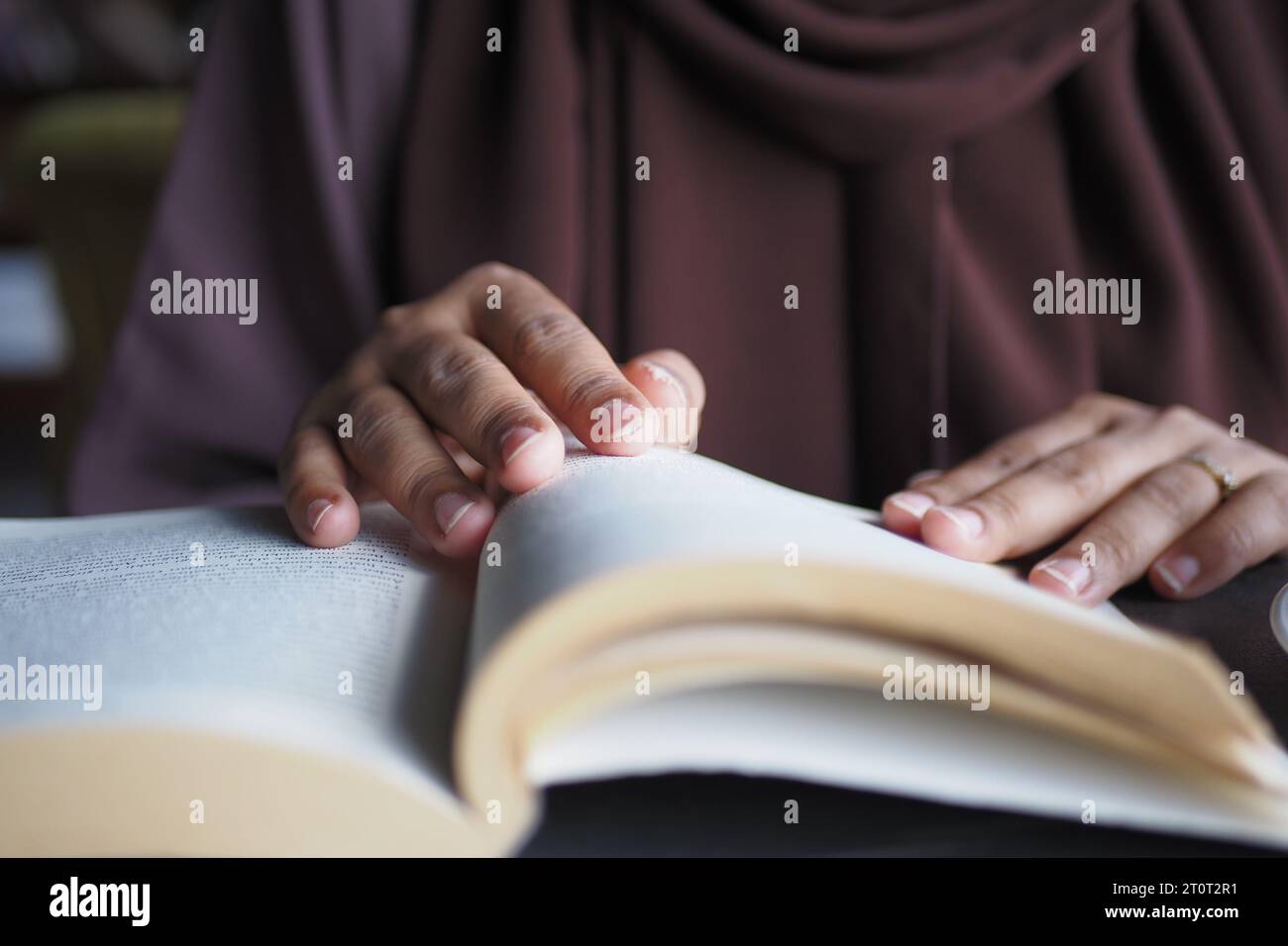 Hand turning a page hi-res stock photography and images - Alamy