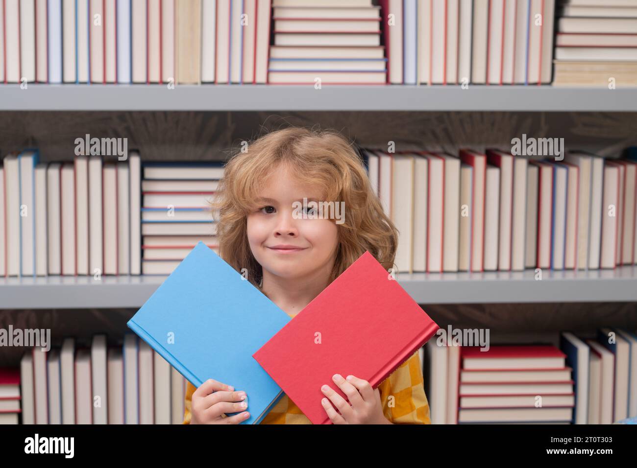 School pupil with pile of books. Children enjoying book story in school ...