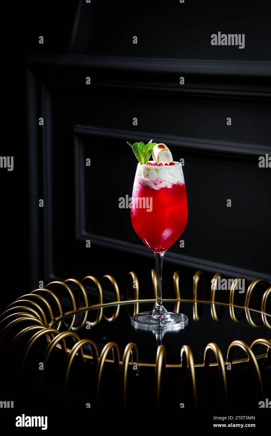 red cocktail on a dark background with whipped cream topping Stock ...