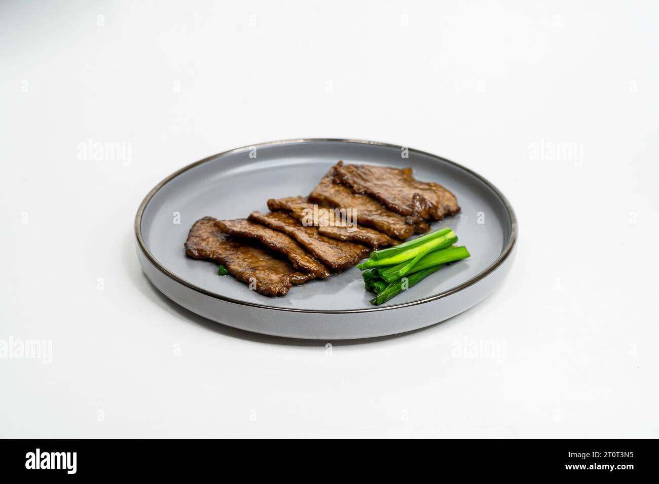 shanghai beef steak with green onion on a grey plate Stock Photo - Alamy
