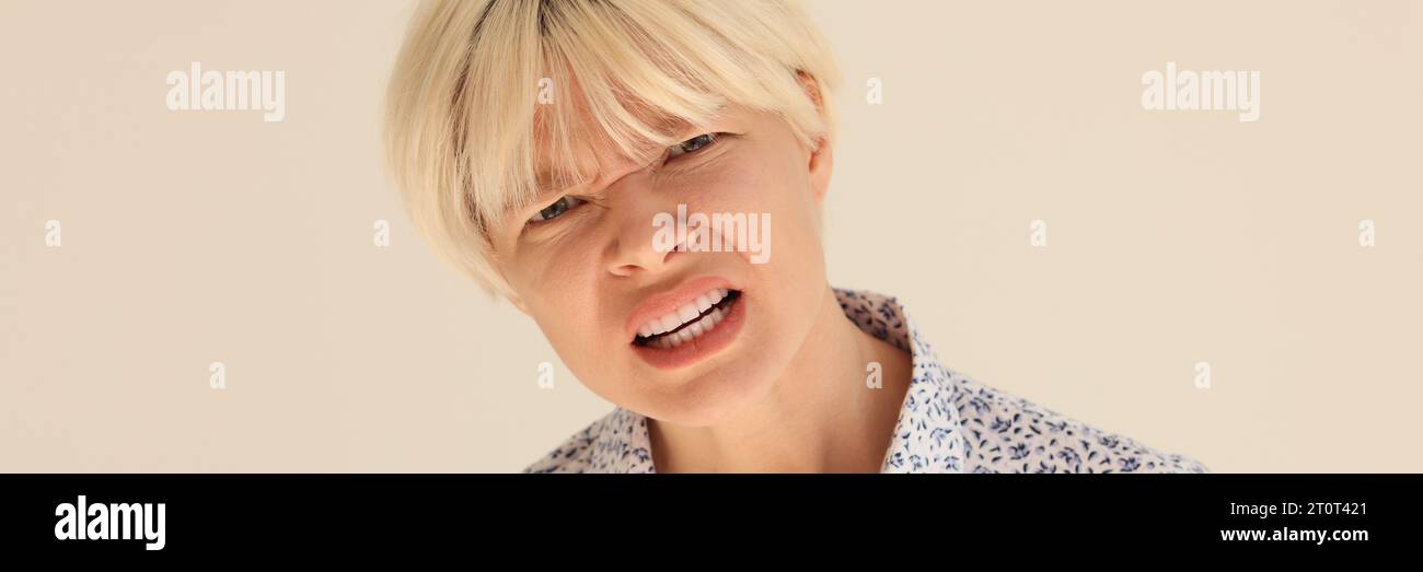 Blonde woman with short haircut opens mouth showing teeth Stock Photo ...