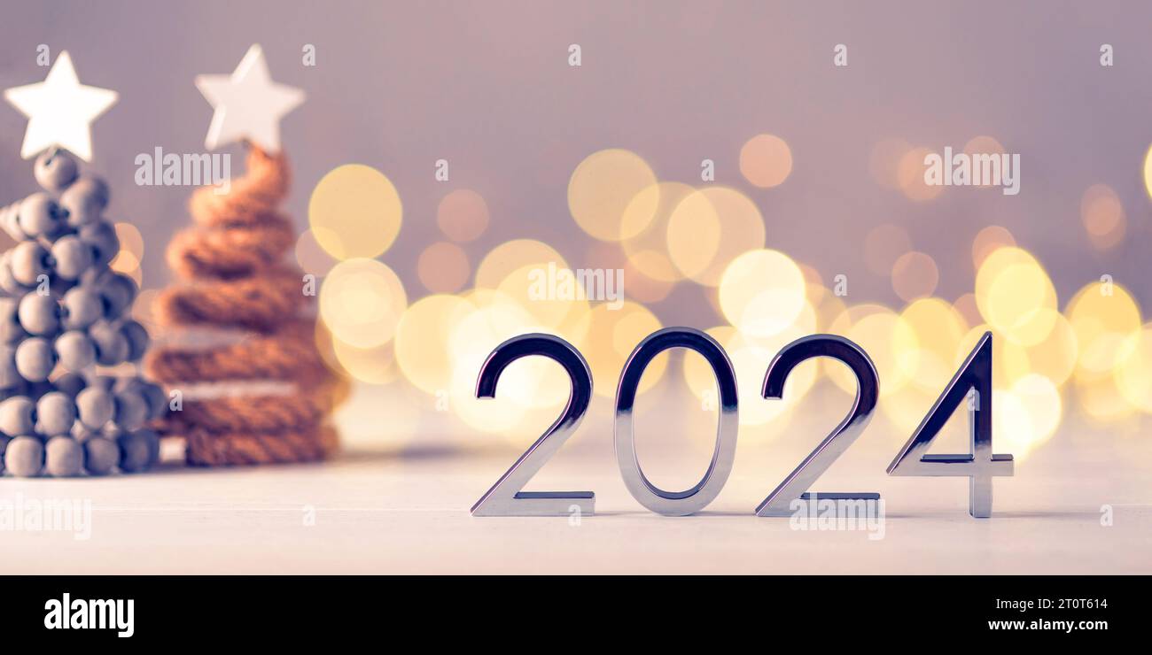 Metal numbers 2024 on table with bokeh lights Stock Photo - Alamy