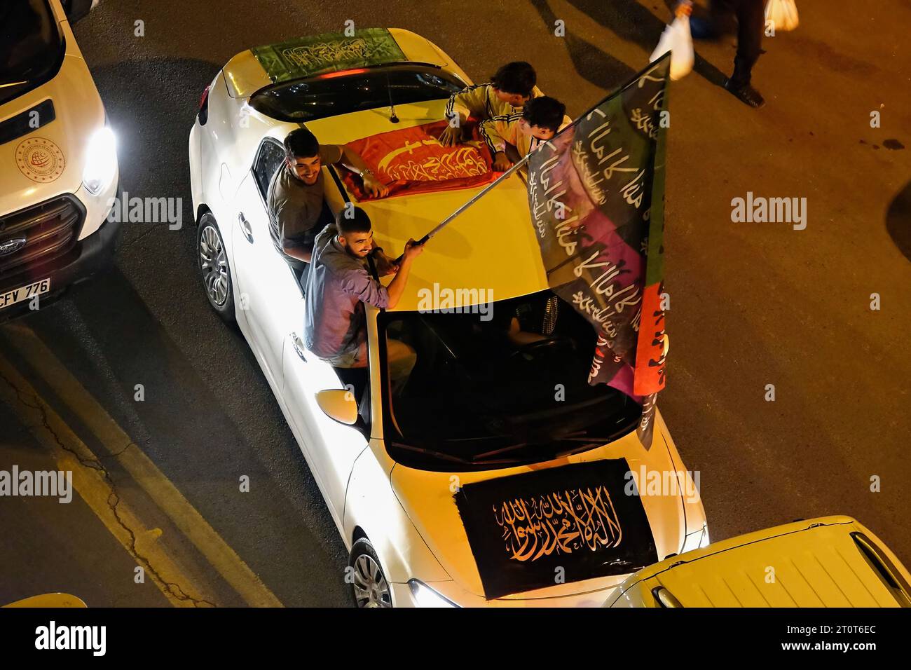 Flags bearing different Islamic slogans and symbols are seen on a car ...