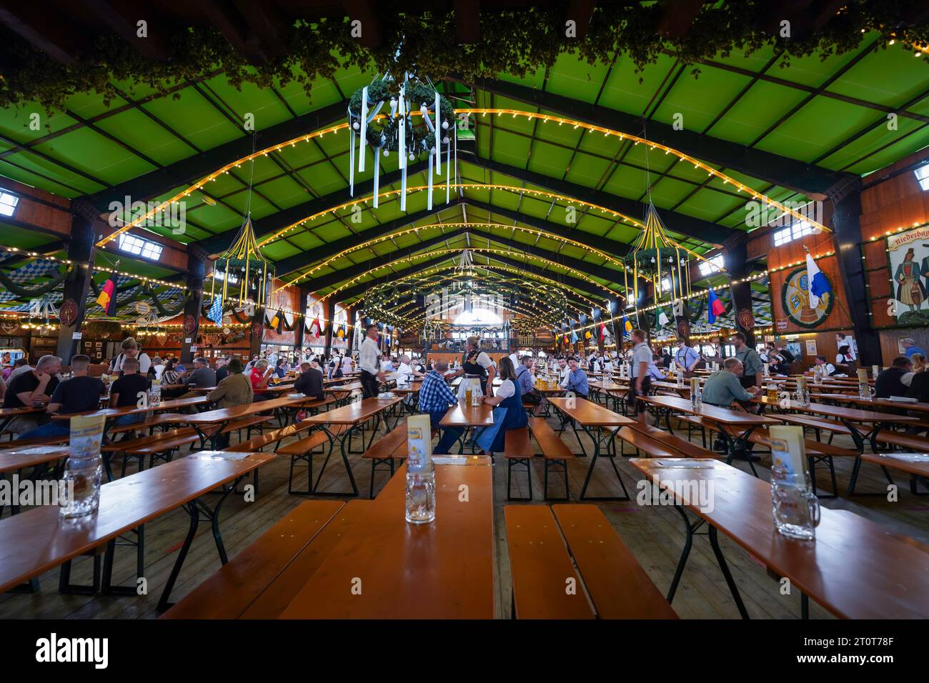 Munich, Germany, EU - September 18, 2023. People drinking and eating ...