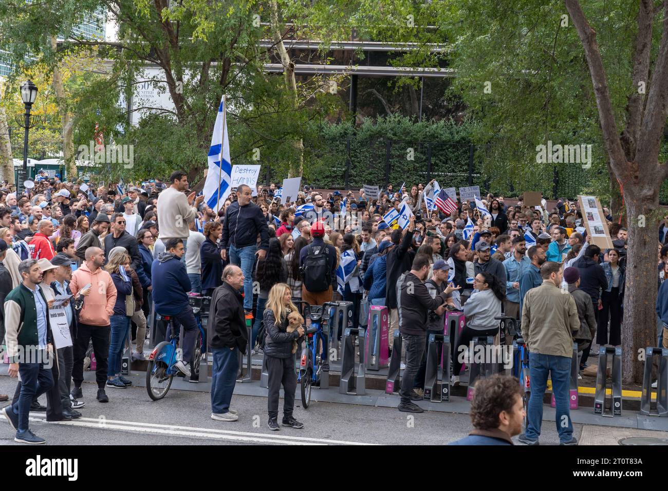 Hundreds of people holding banner, signs and Israeli flags gather at a ...