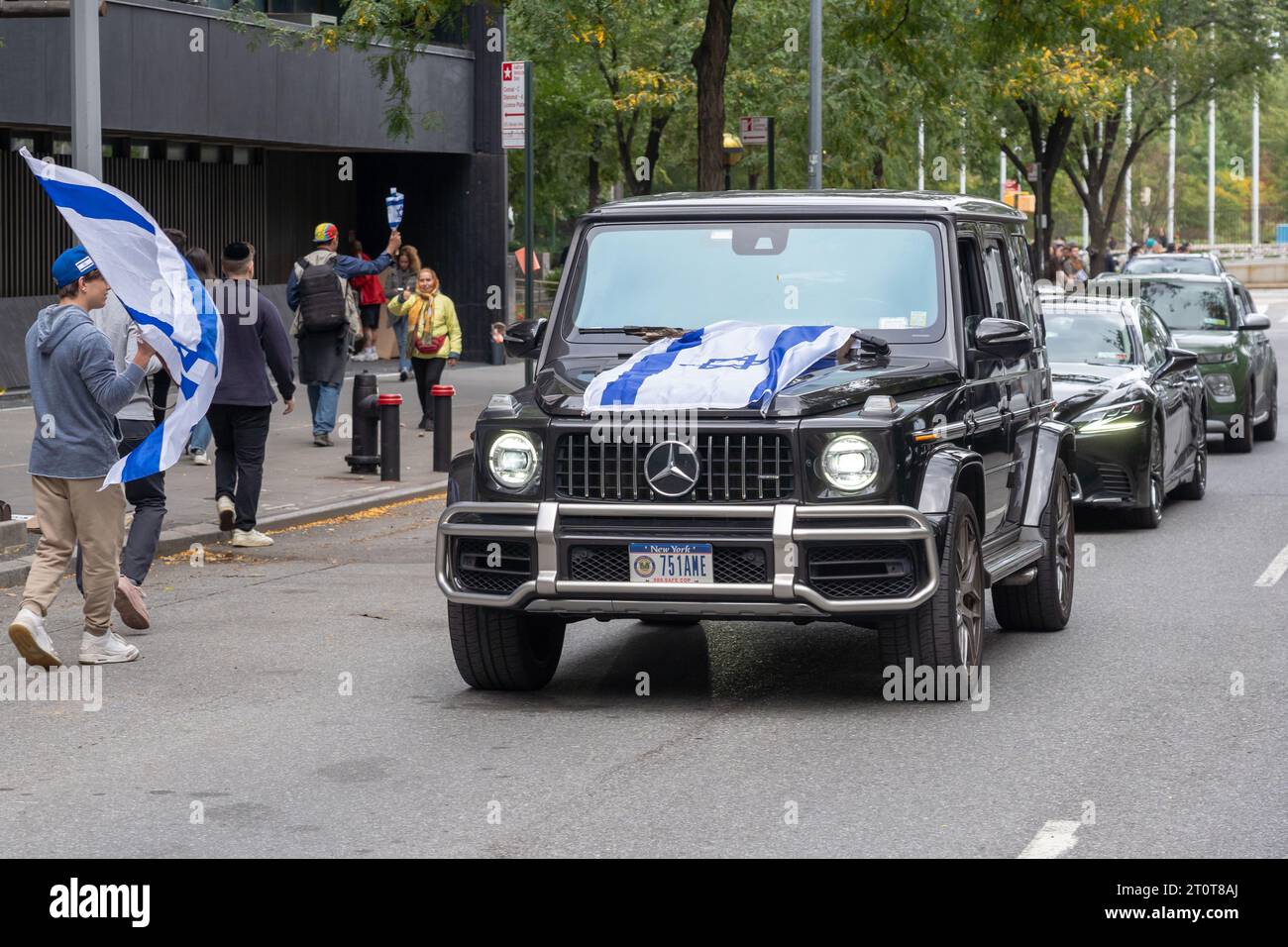 A car adorn with Israeli flag drives by at a pro-Israel rally outside ...