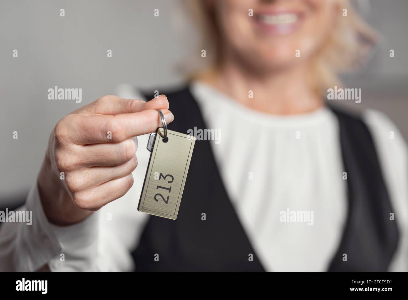 Closeup of hotel key. Lady gives room key to customer Stock Photo - Alamy