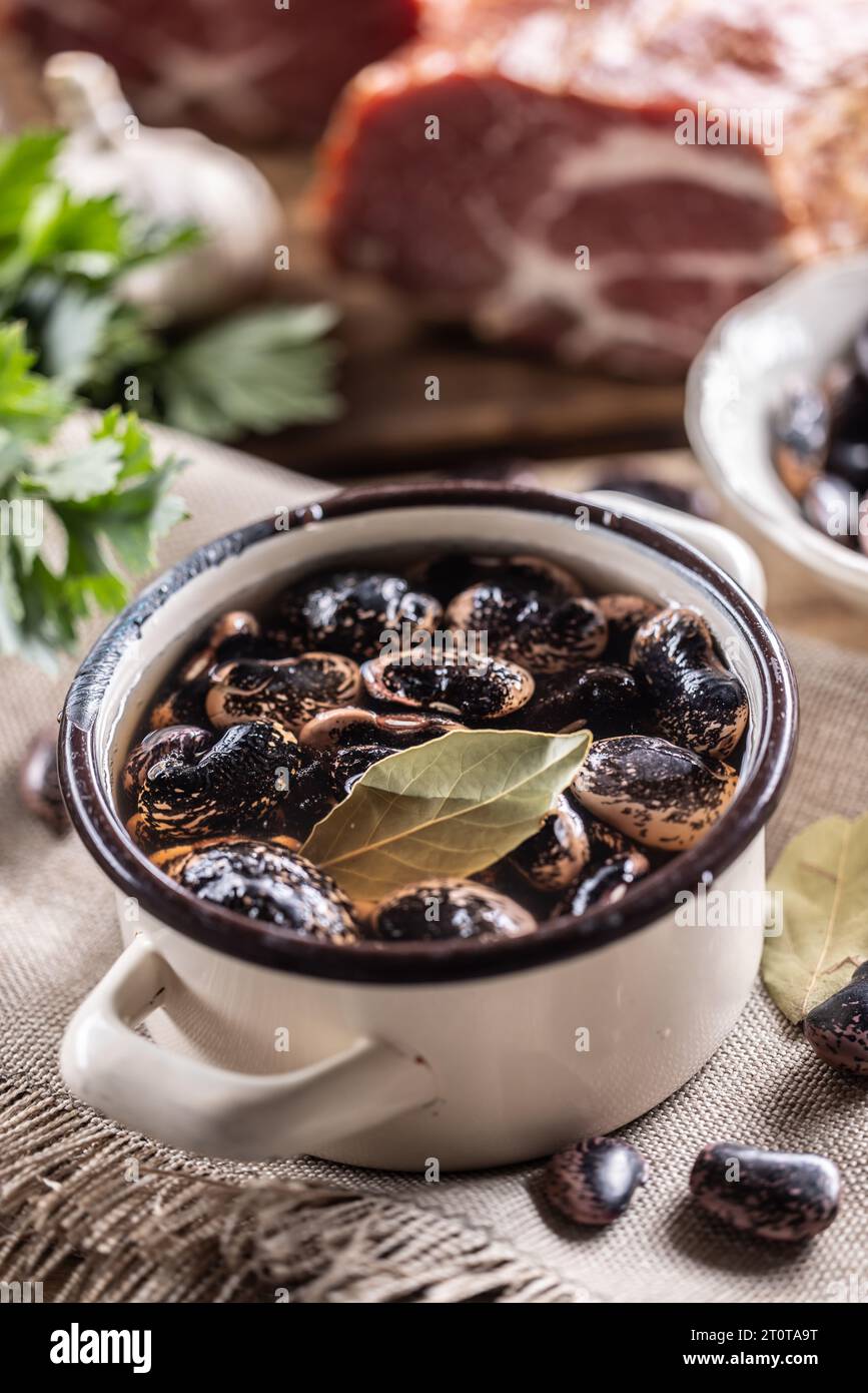 Raw beans in a pot soaked in water the day before cooking to soften ...