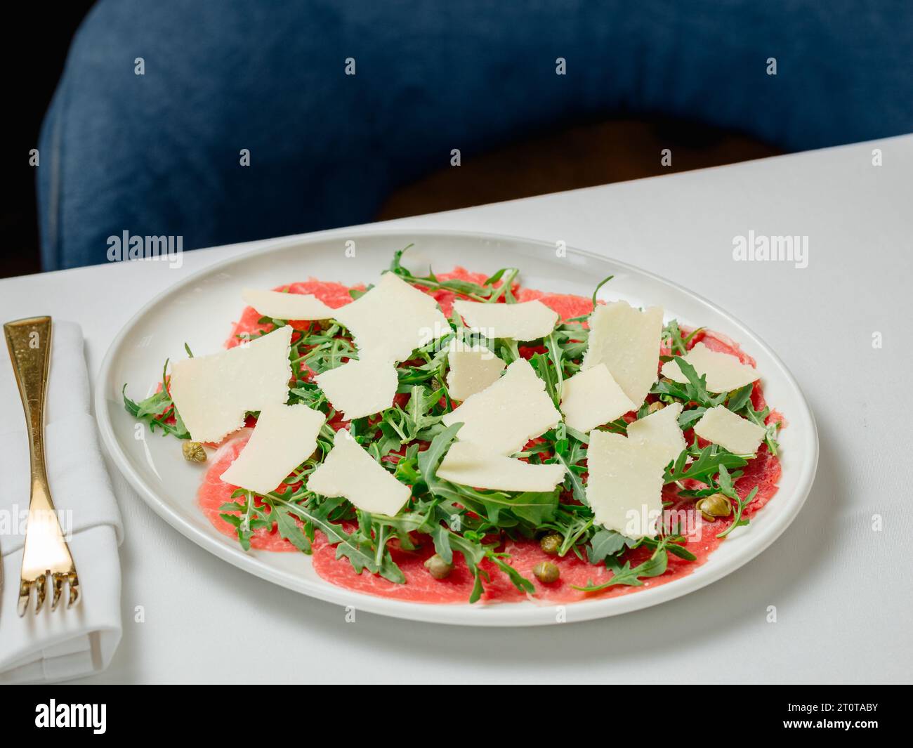 Beef Carpaccio cold appetizer with parmesan, capers and arugula on ...