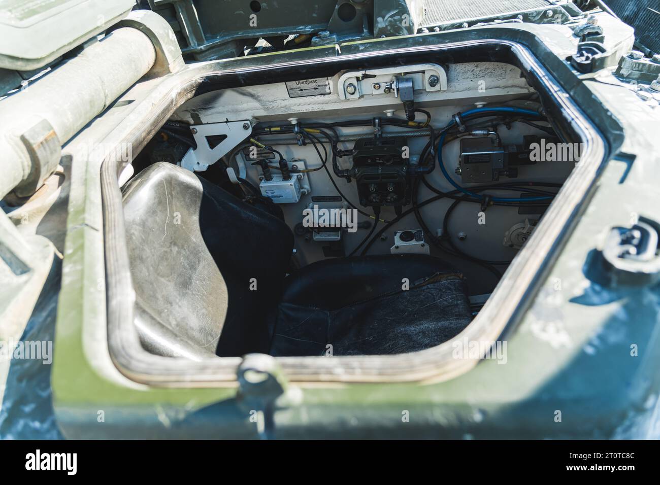 The insides of a tank. Driver's tank cabin open for the civilians to ...