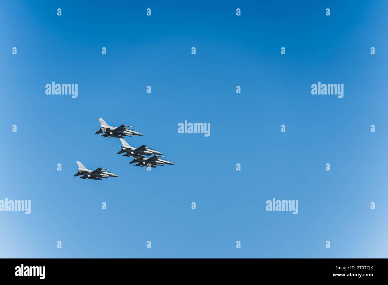 Four fighter planes in airshow on blue sky. Open-air military parade ...