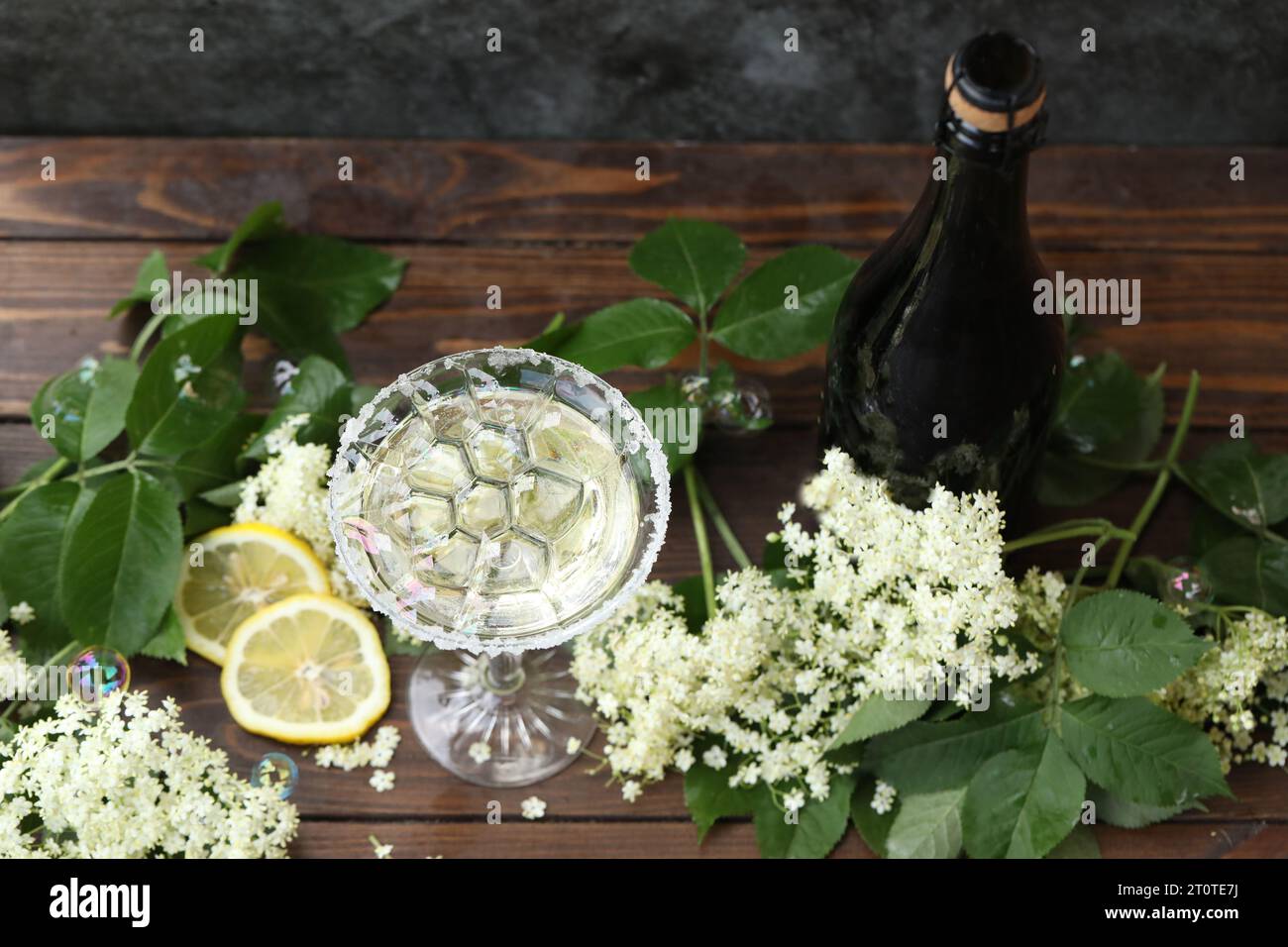 Glass of champagne with elderflower liqueur. Decorated with white elder ...