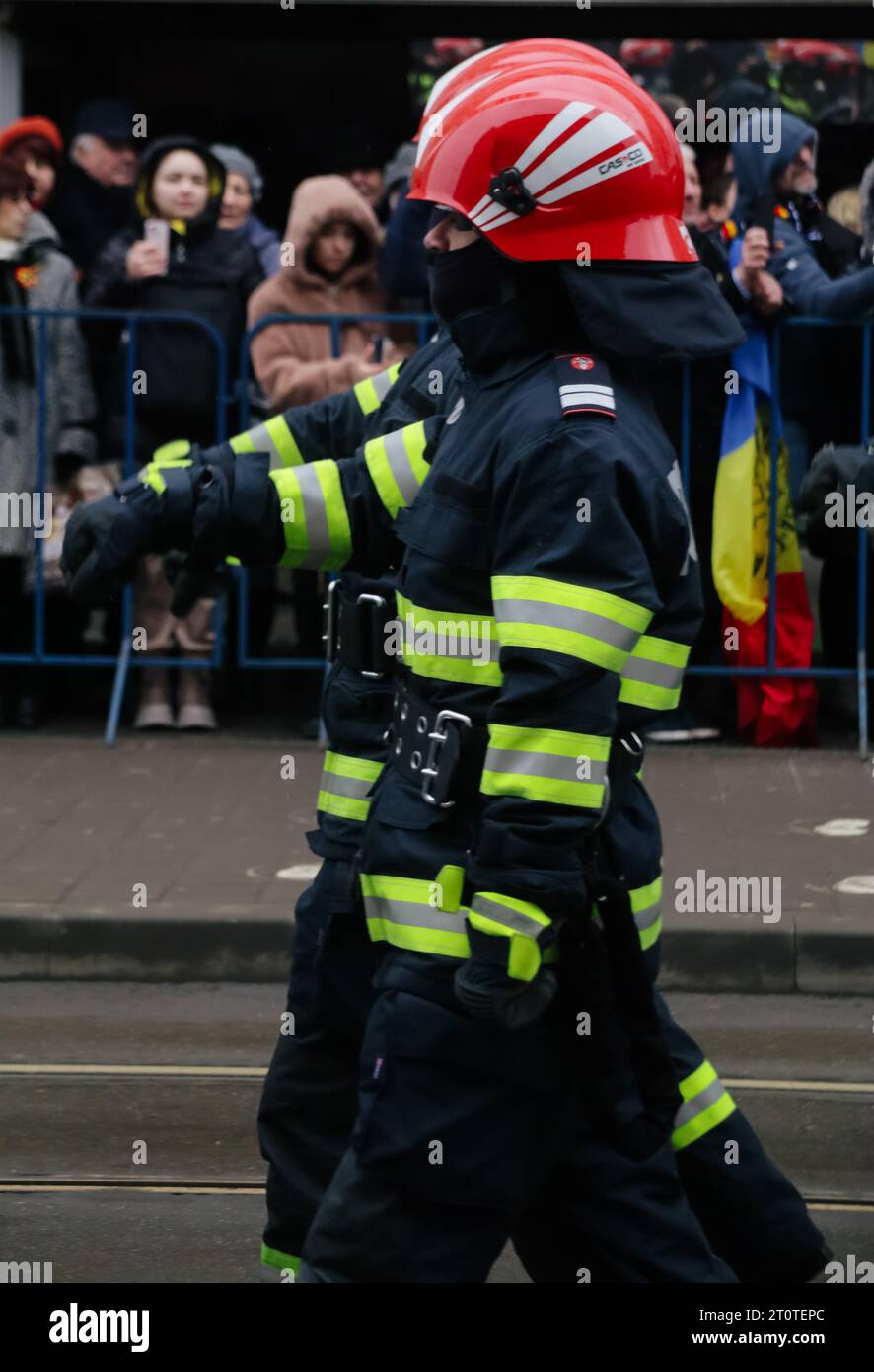 Two firefighters wearing full professional firefighting gear stand in ...