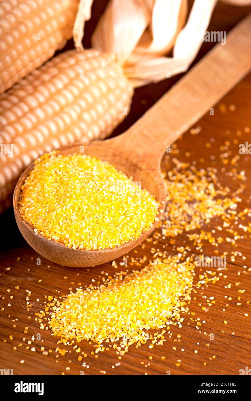 Corn meal polenta in wooden bowl and dry corn cobs isolated on white ...