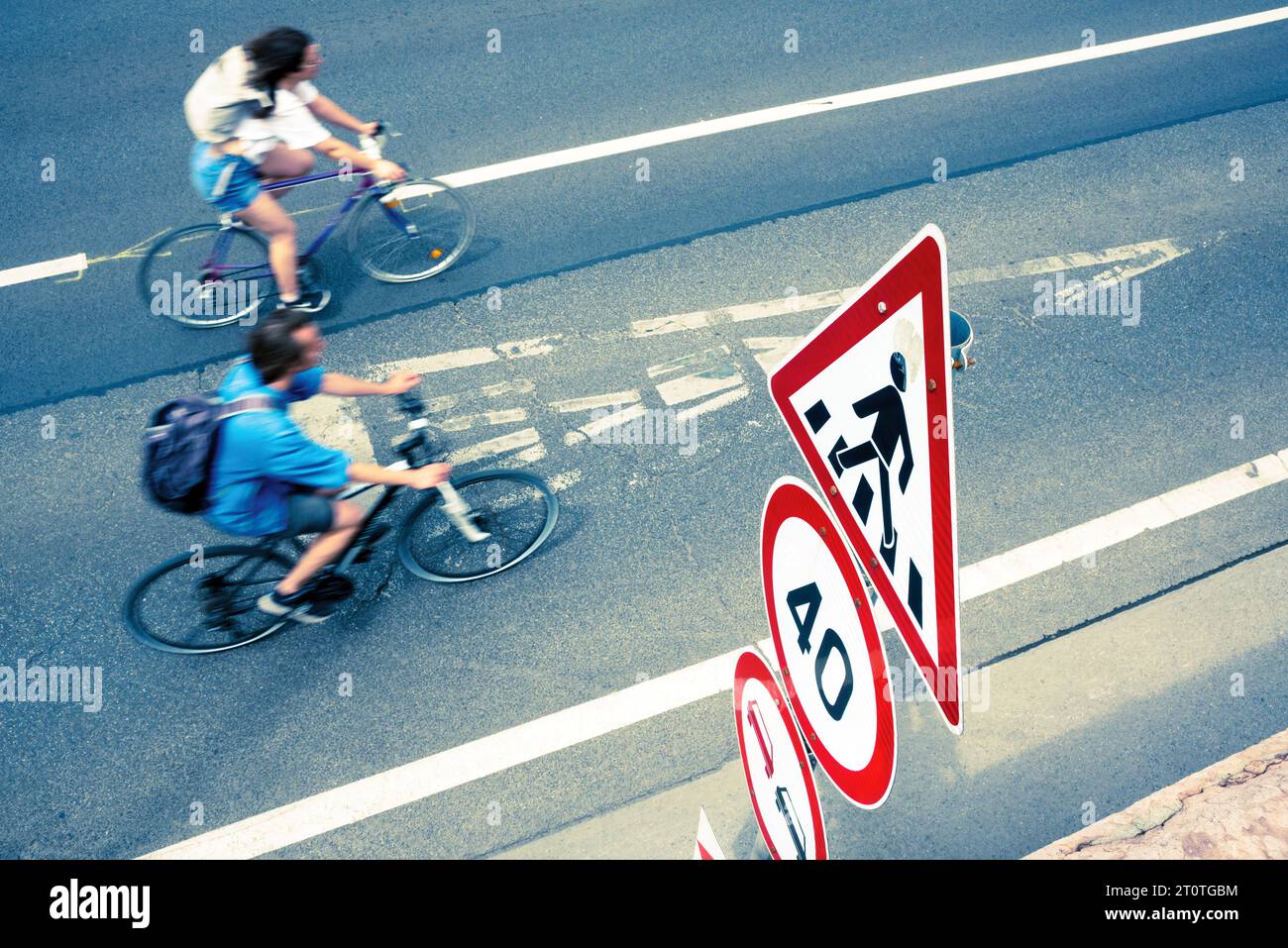 Road signs against young people riding bikes Stock Photo - Alamy