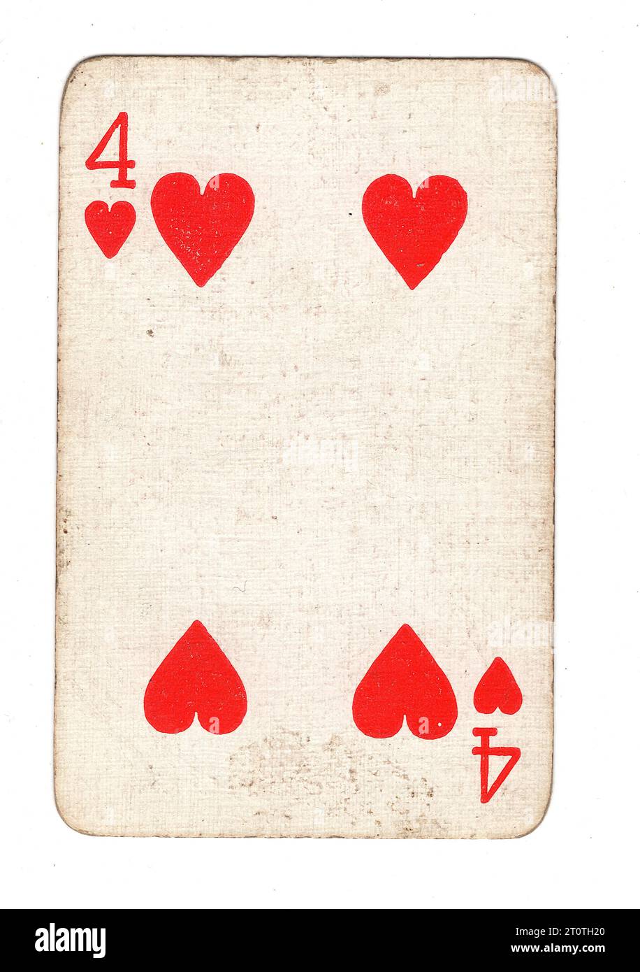 A vintage four of hearts playing card isolated on a white background ...