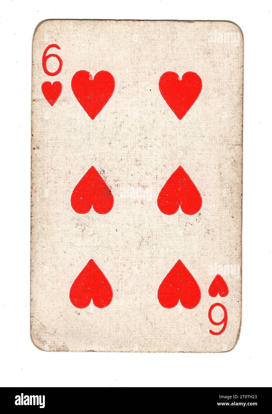 A vintage six of hearts playing card isolated on a white background ...