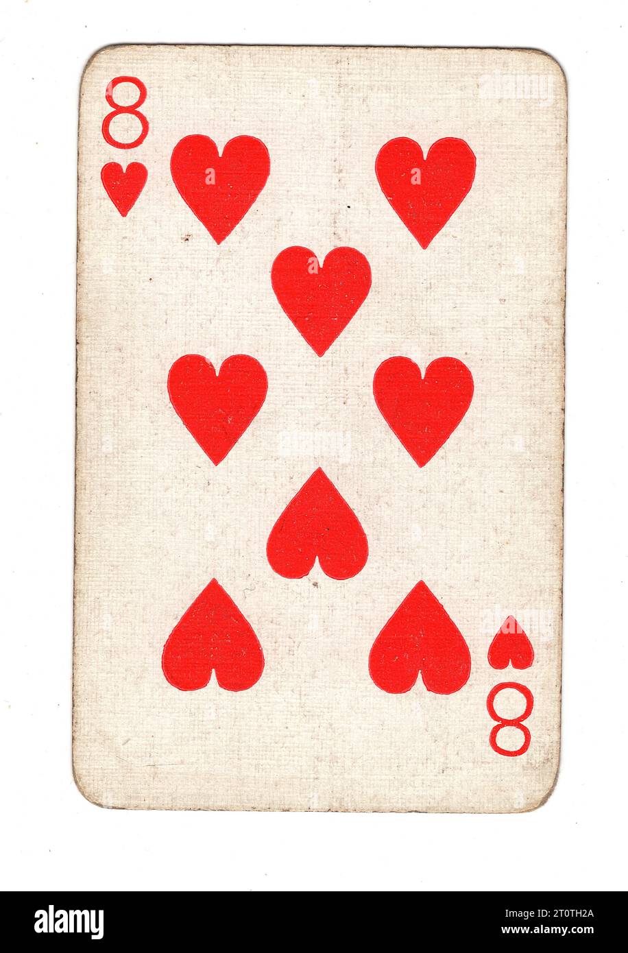 A vintage eight of hearts playing card isolated on a white background ...
