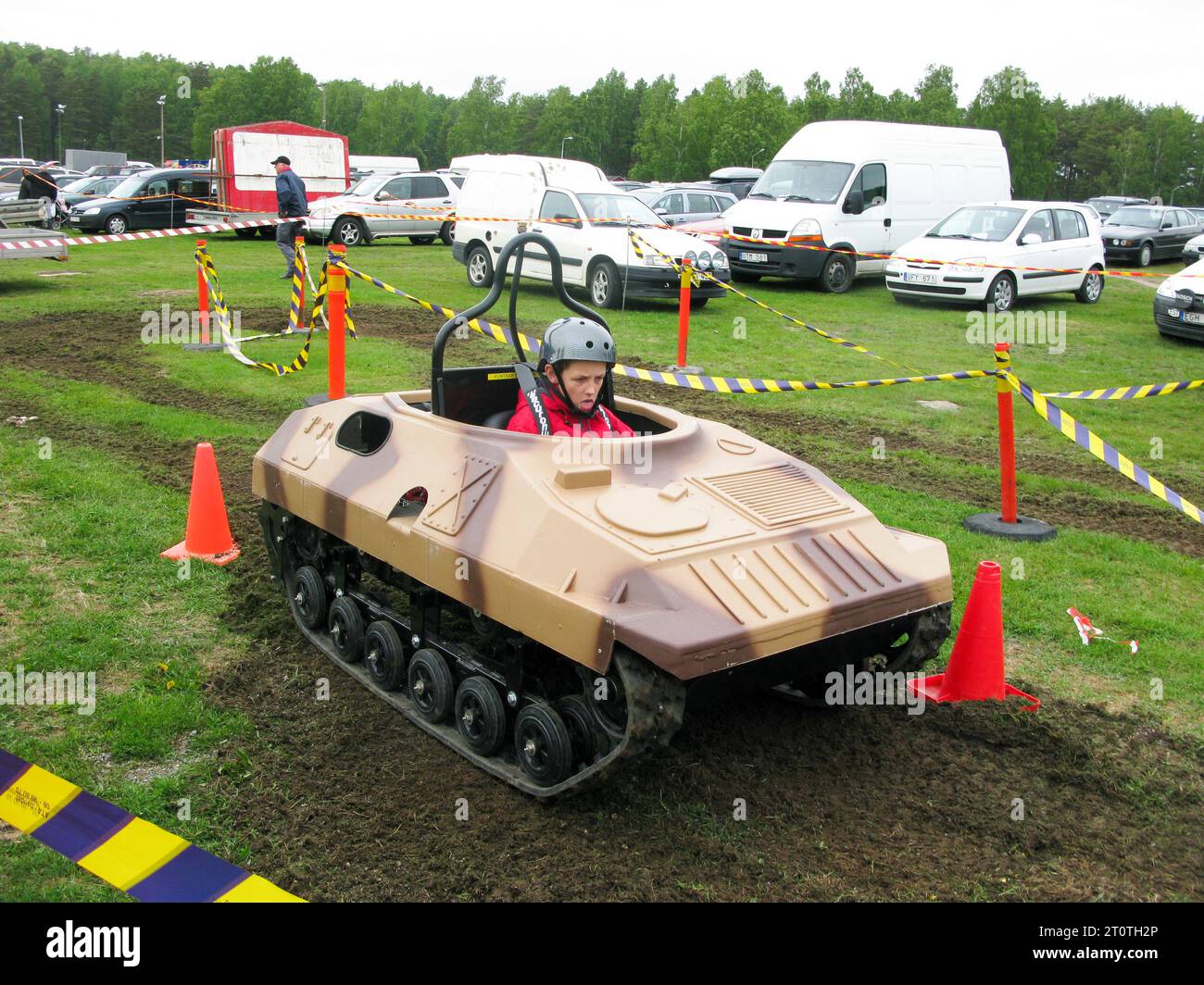 YOUNG GUY in a pedal car design like a tank Stock Photo - Alamy