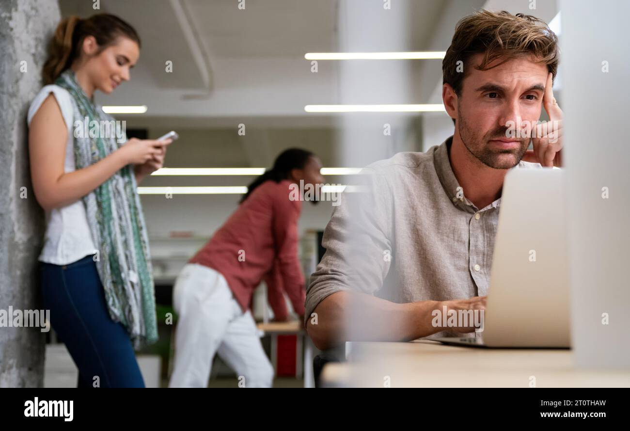 Stressful job. Stressed young businessman working at laptop, having ...