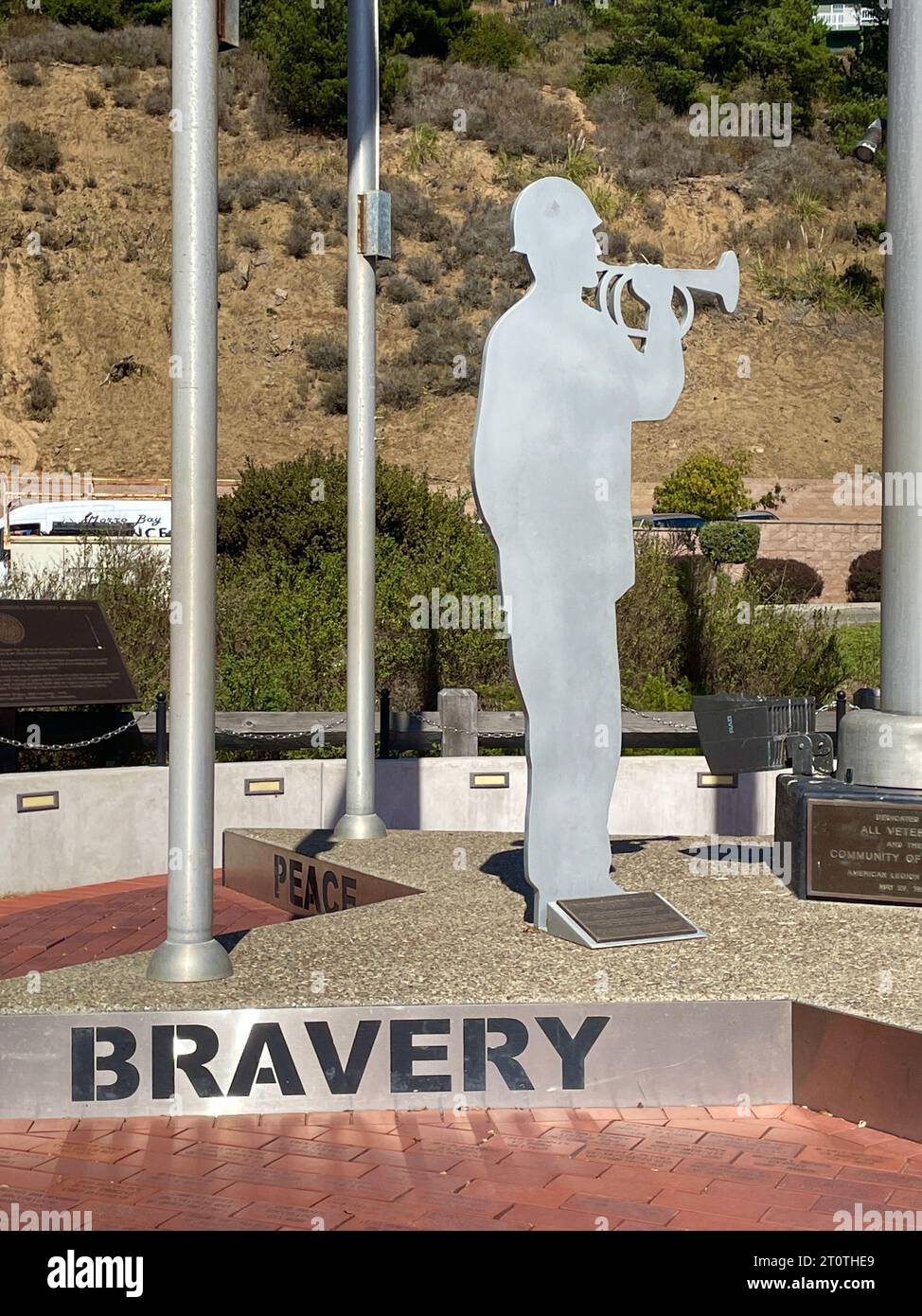 A bronze sculpture of a man, standing tall and proud with a trumpet in ...