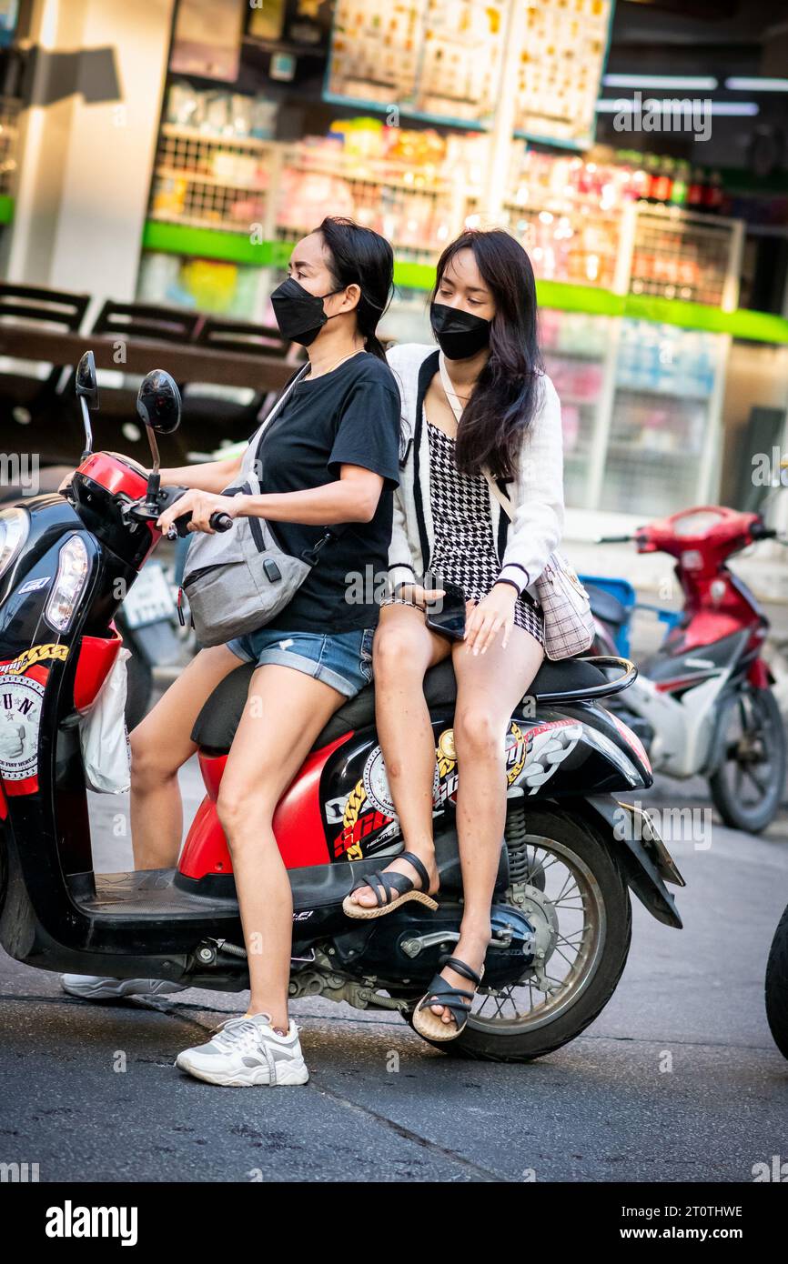 Local Thai people, tourists and residents rush past the busy junction ...
