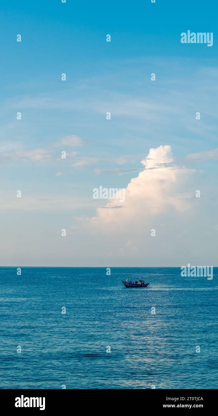Sea sky cumulus cloud landscape view background. Calm water alone fishing boat. Destination aim ...