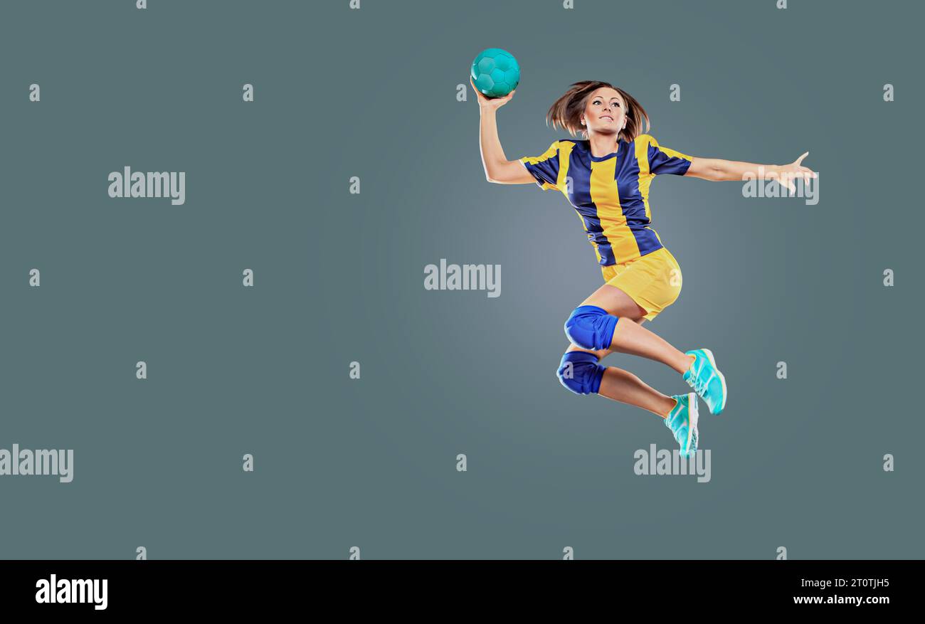 female handball player with a ball in action Stock Photo - Alamy