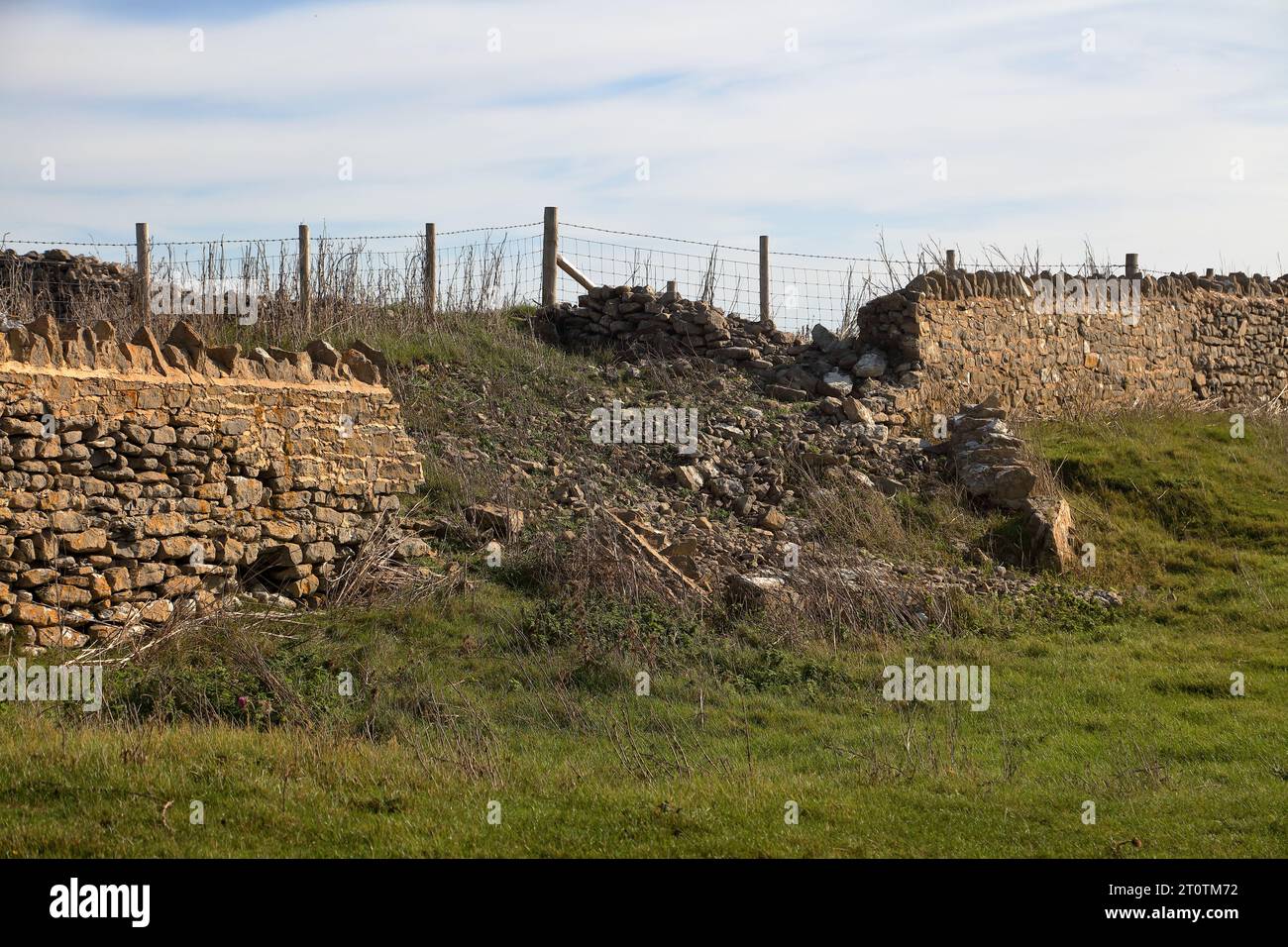 A beautiful old dry stone wall recently repaired now falling down due ...