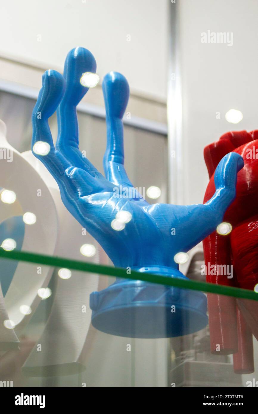 Art object printed on 3D printer. Prototype hand with fingers of blue ...
