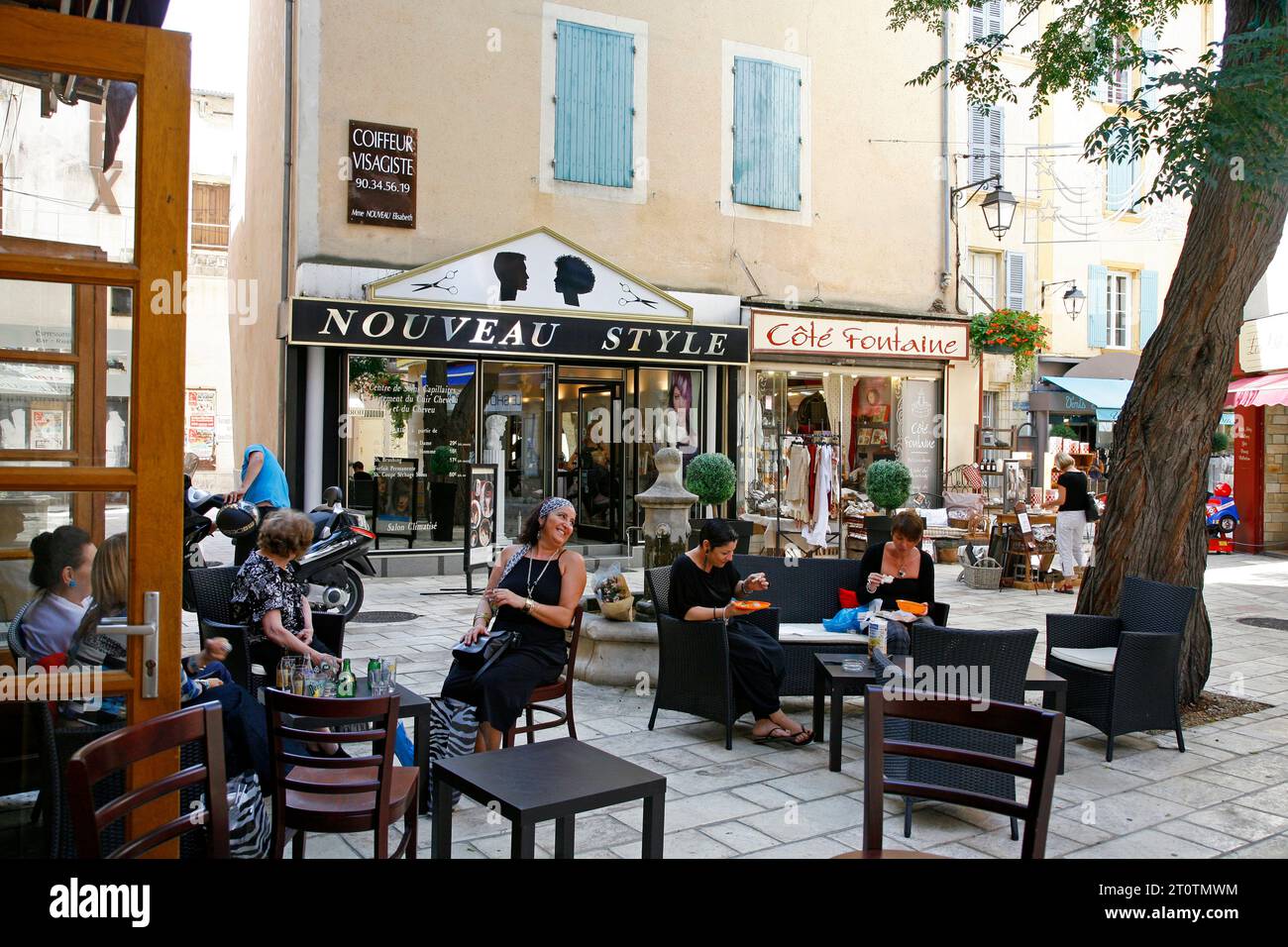 People sitting at a cafe in the central district, Orange, Vaucluse ...