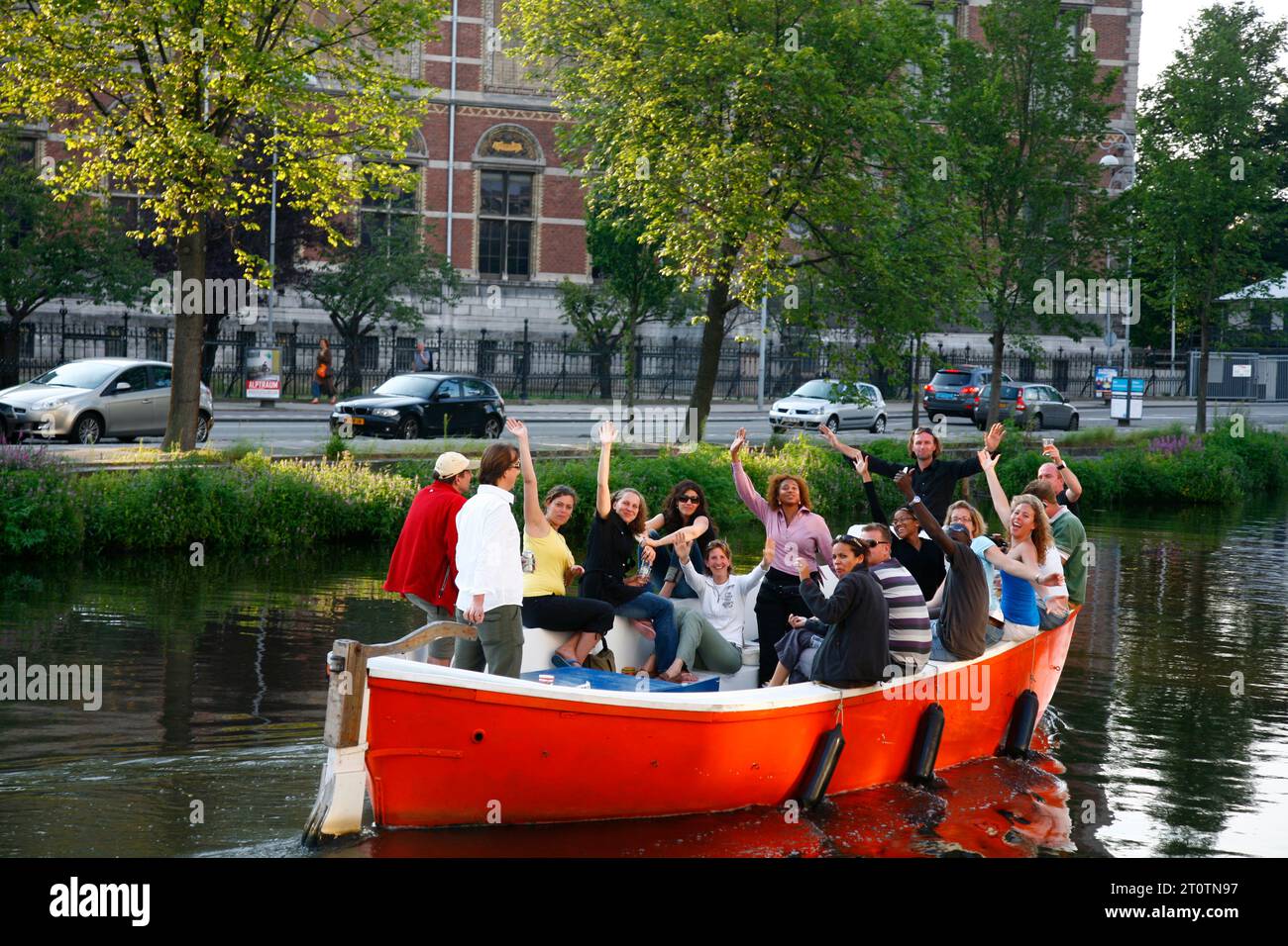 People cruising their boat at a canal, Amsterdam, Holland Stock Photo ...
