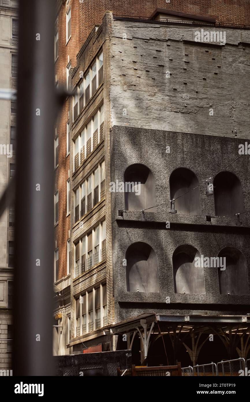 stone decor on brick buildings on urban street in downtown, creative ...