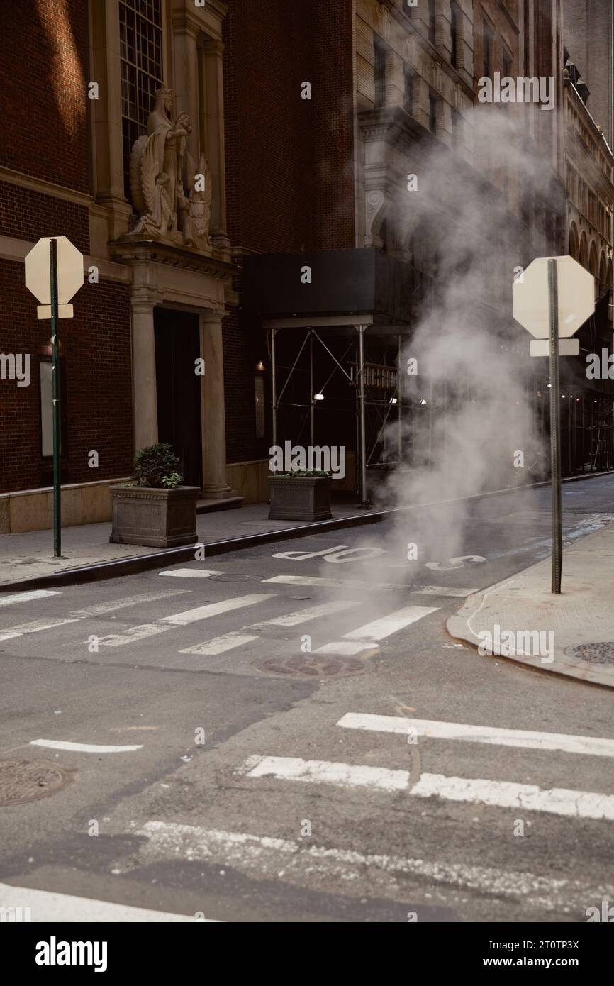 steam on urban street with vintage buildings and pedestrian crossing ...